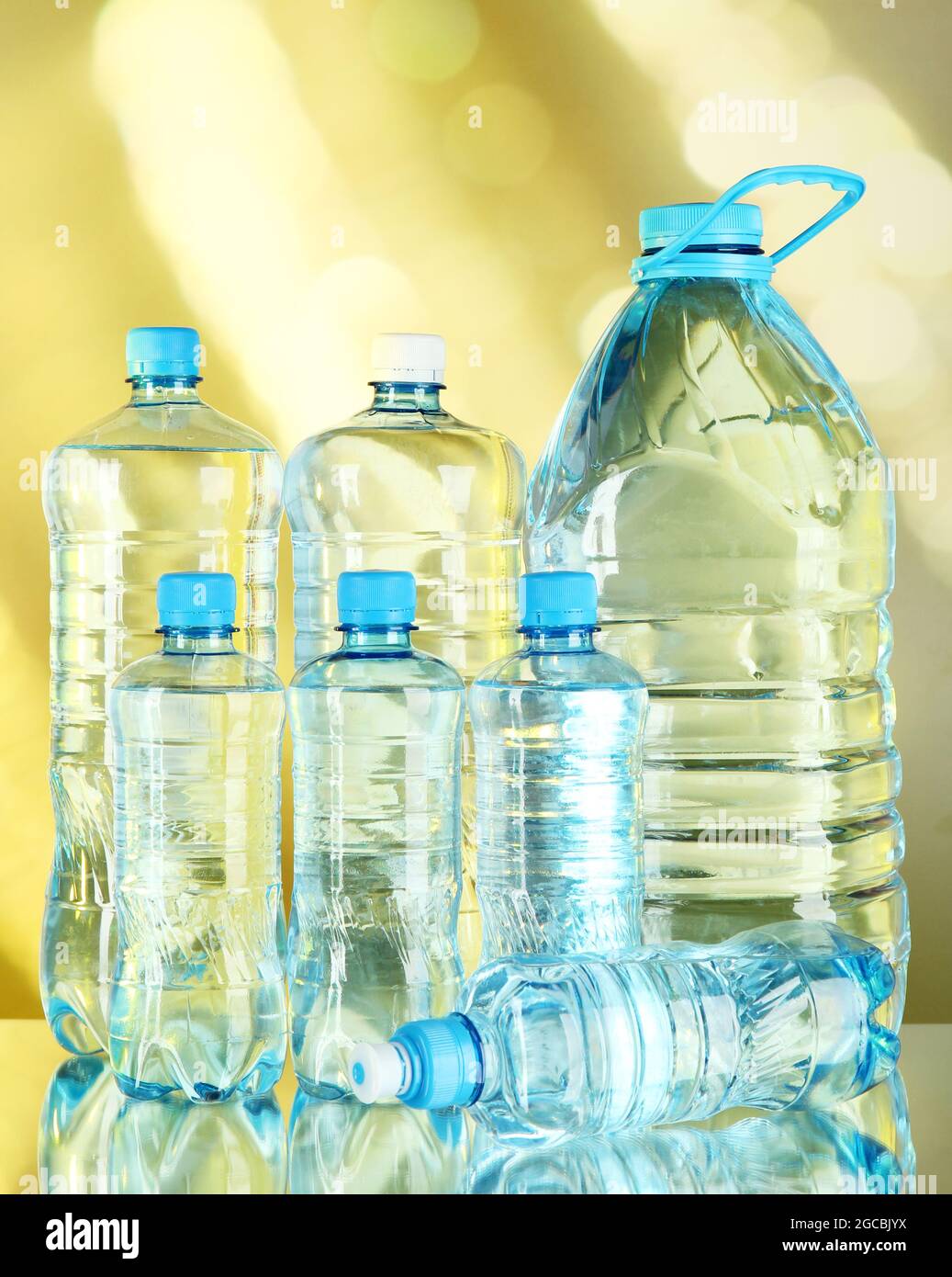 Water in different bottles on light background Stock Photo - Alamy