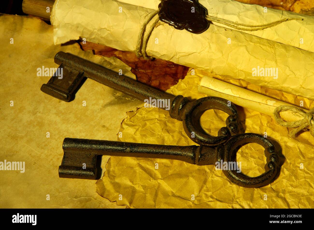 Antique keys and scroll on dark background Stock Photo - Alamy