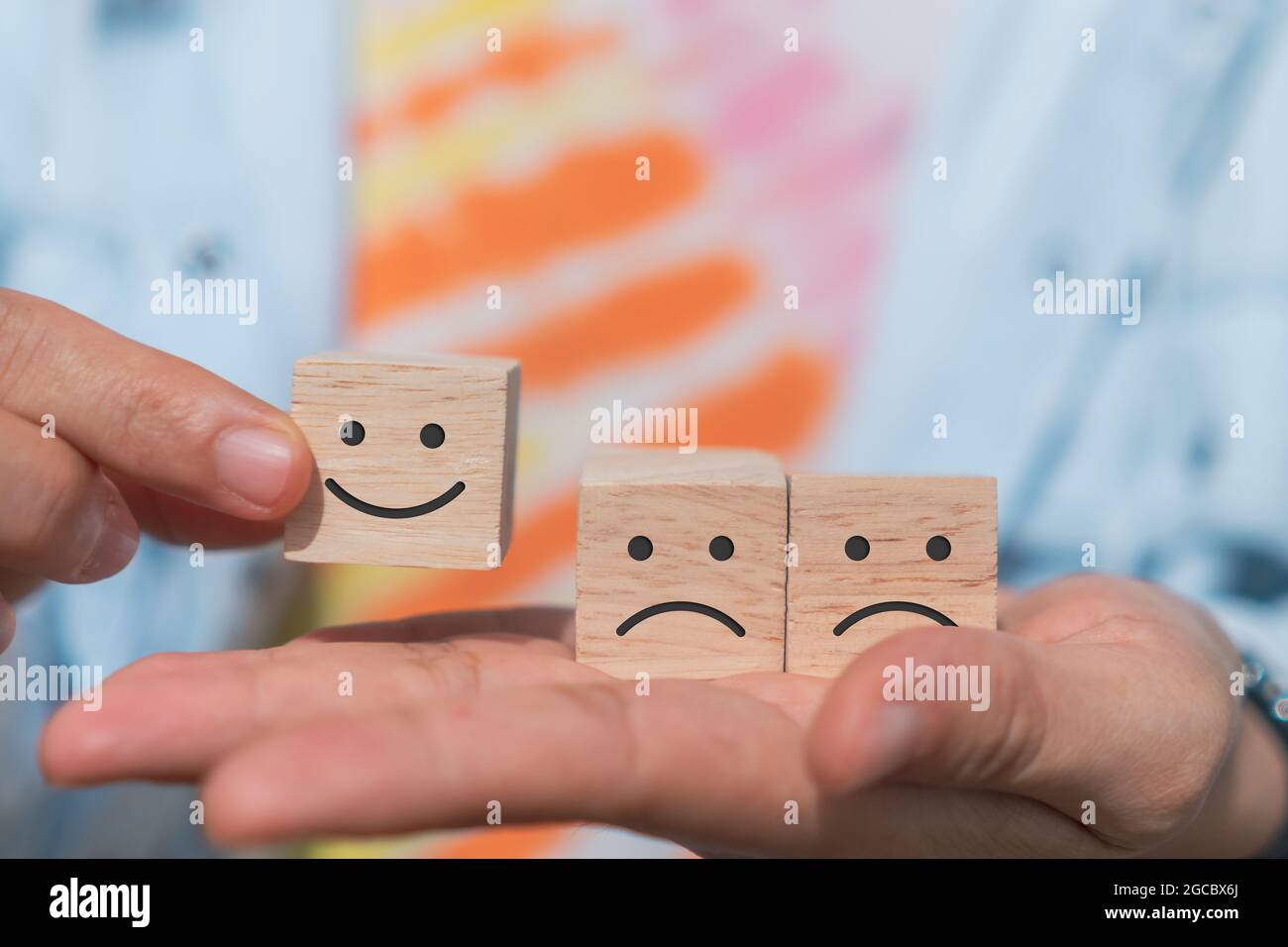 Smile face and cart icon on wood cube. Optimistic person or people ...