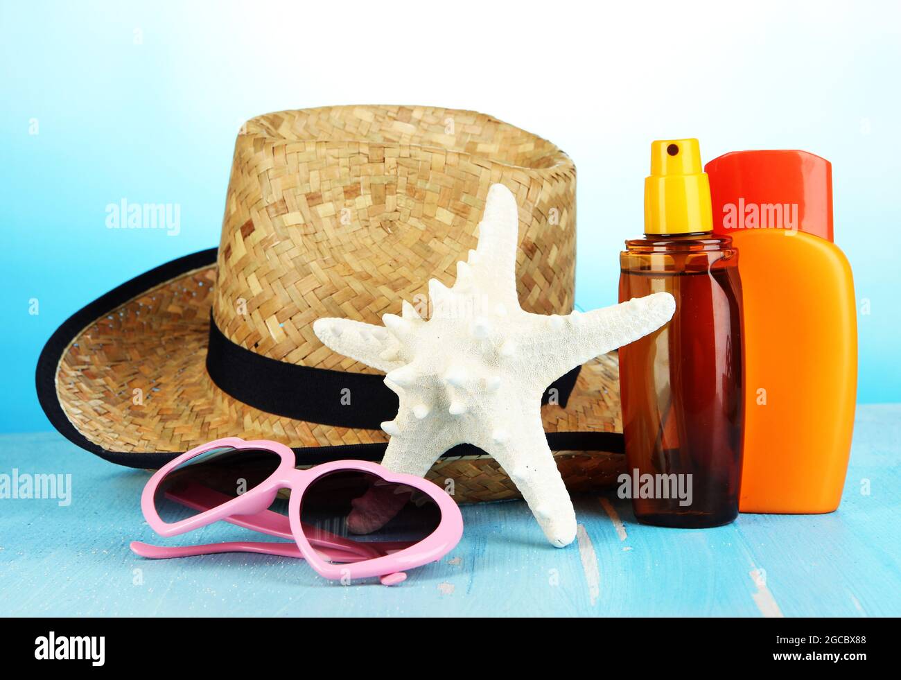 Beach items on beach background Stock Photo - Alamy