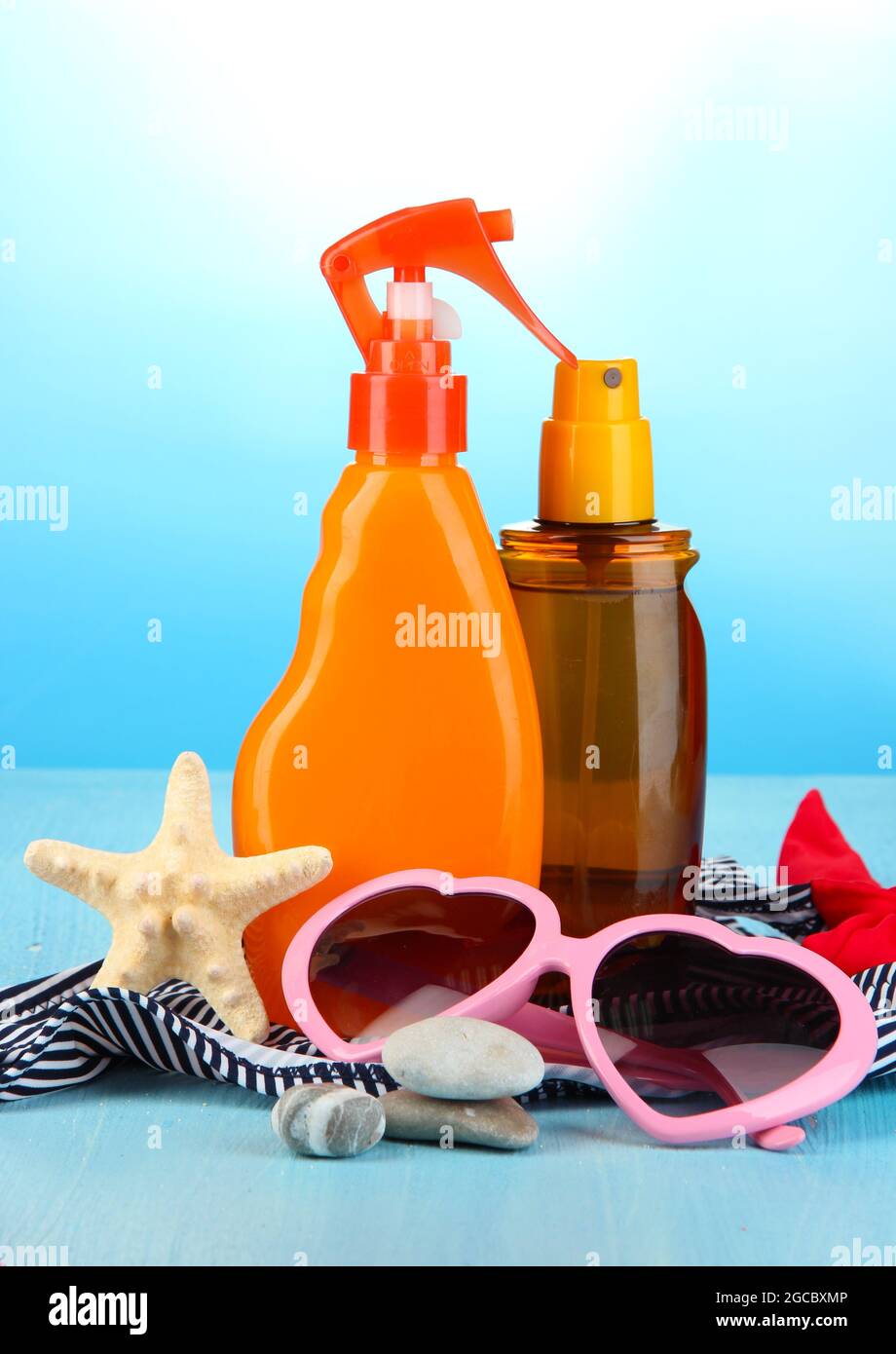 Beach items on beach background Stock Photo - Alamy