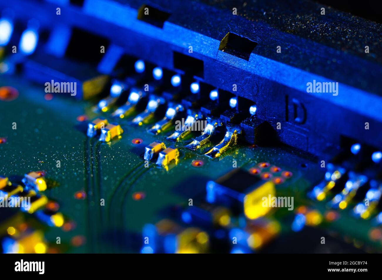 Old electronic circuit board close up in macro photography, blue and ...