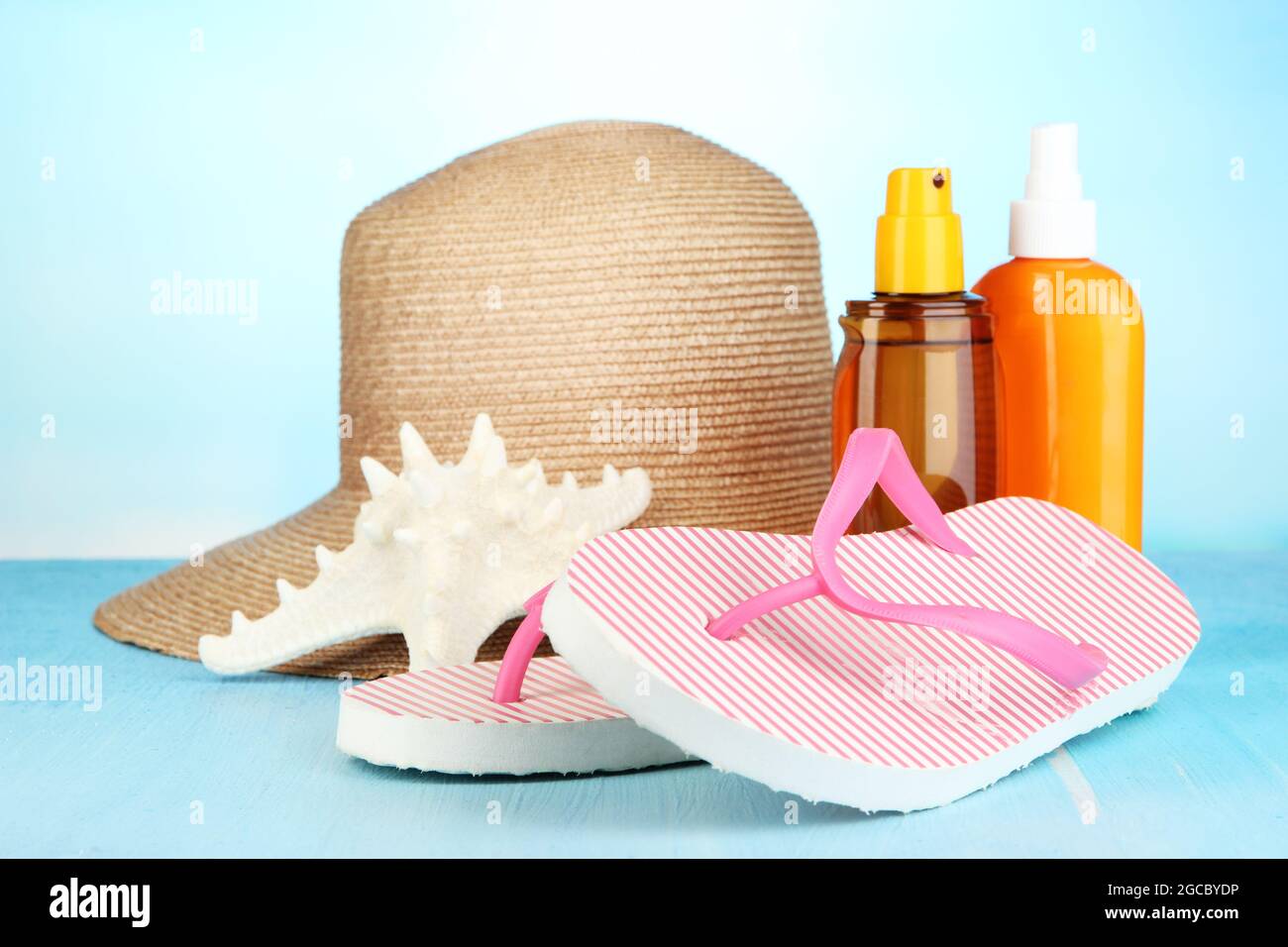 Beach items on beach background Stock Photo - Alamy