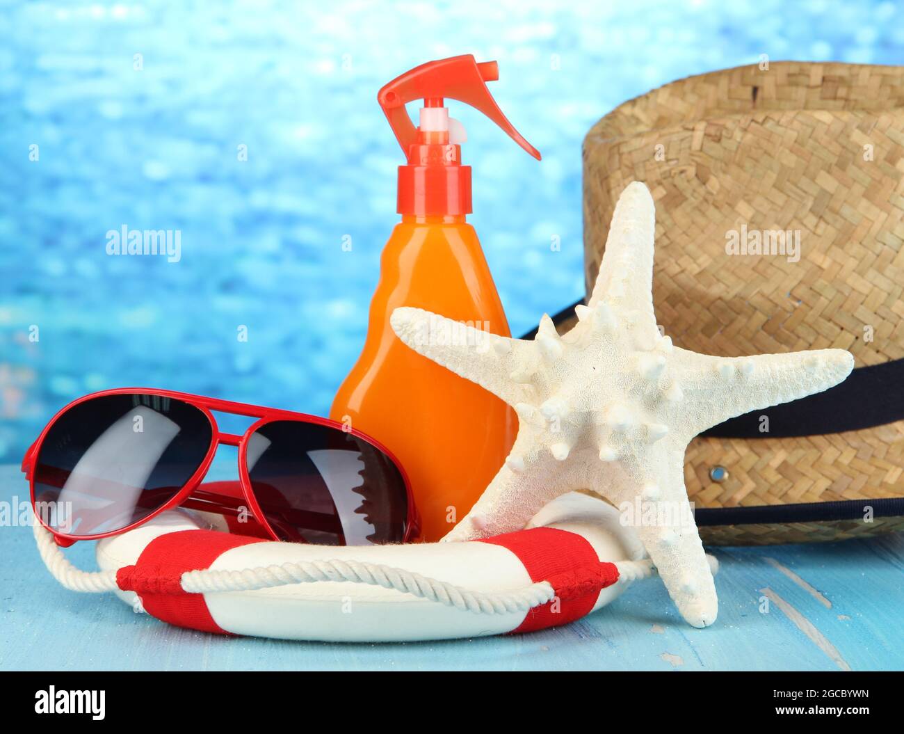 Beach items on beach background Stock Photo - Alamy