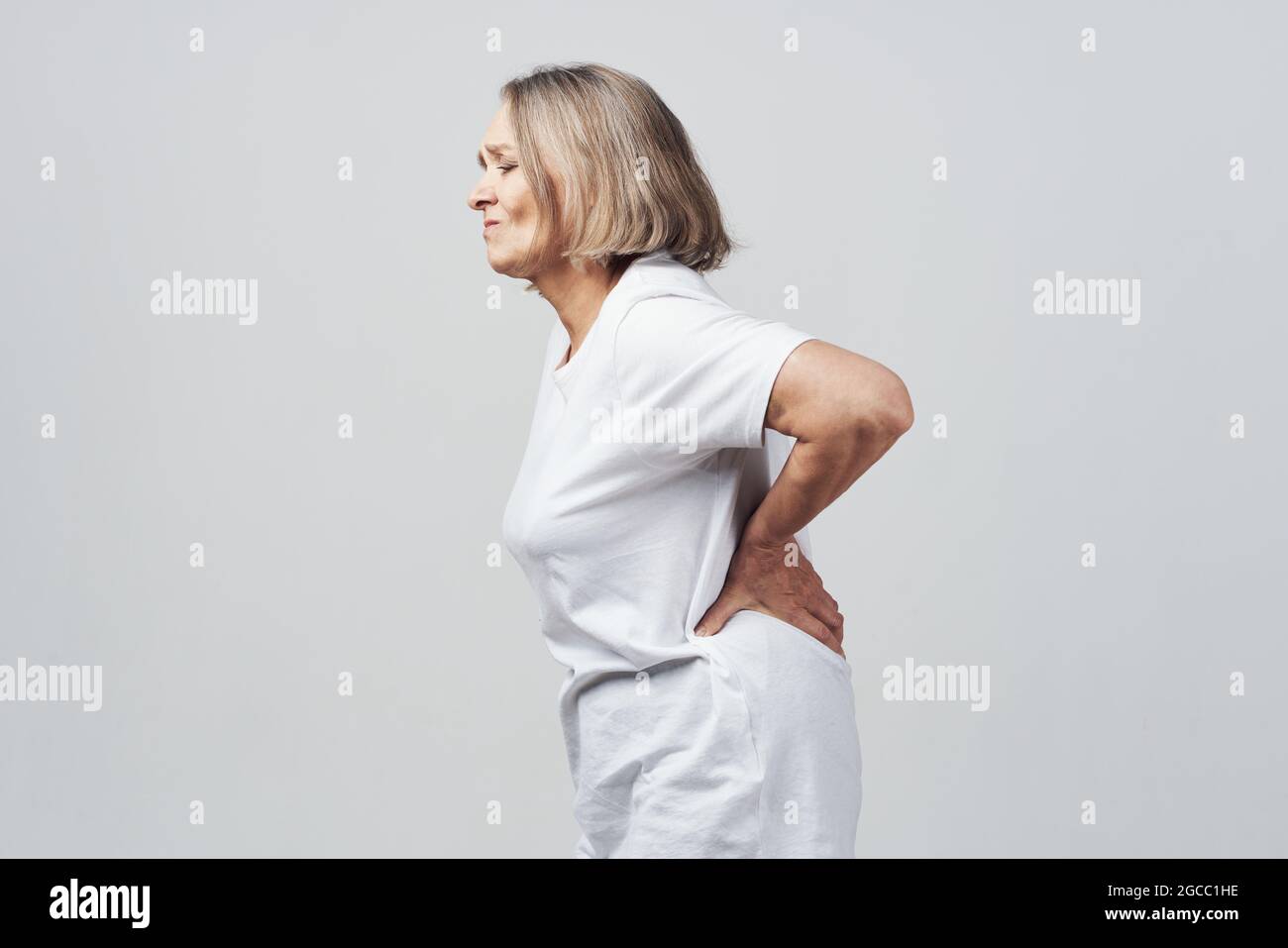 elderly woman holding her lower back back pain treatment Stock Photo ...