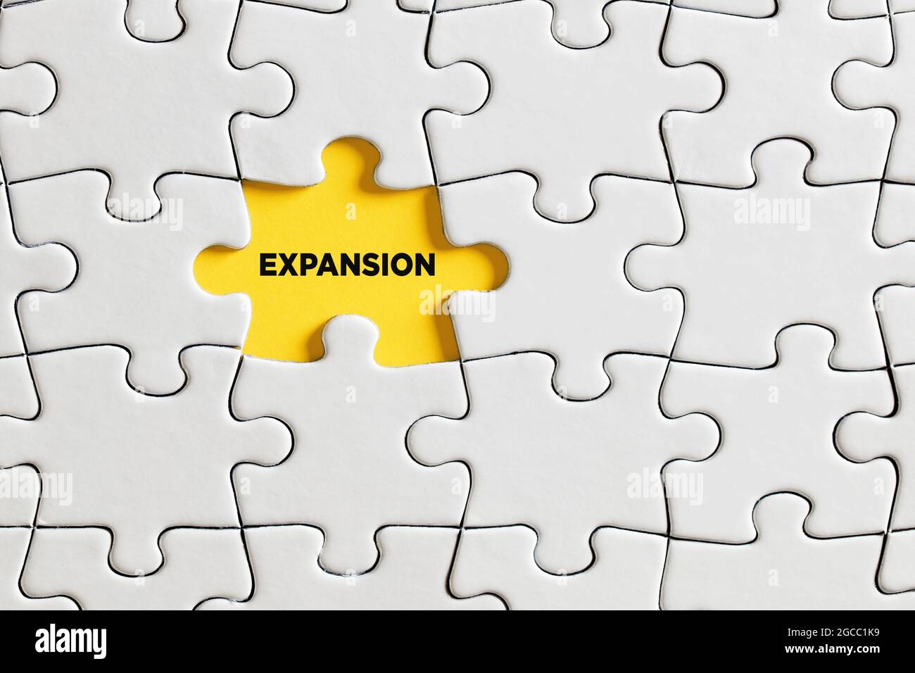 The word expansion written on missing puzzle piece. To expand market ...