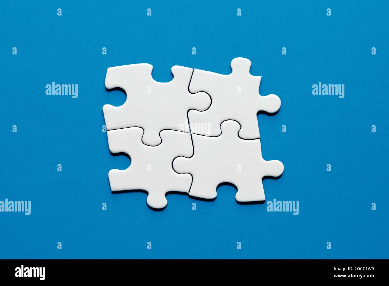 Four puzzle pieces connected to each other. Teamwork, synergy ...