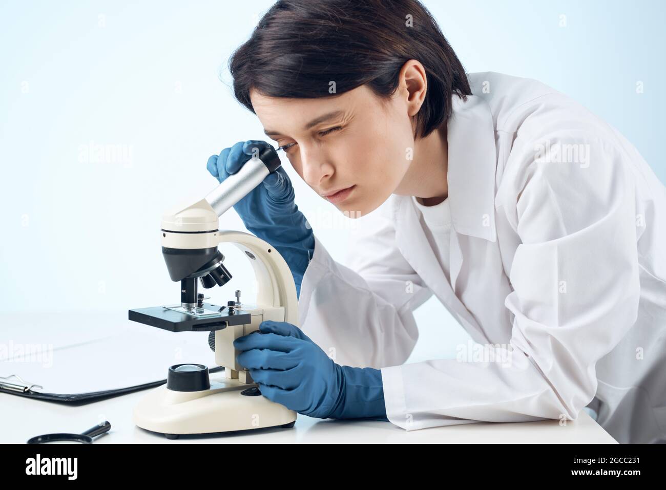 woman in laboratory microscope science research analysis Stock Photo ...