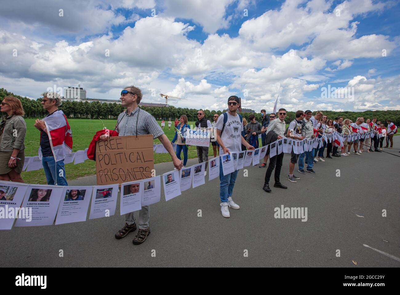 Protesters hold paper-chain of photos showing some of the 600 victims ...