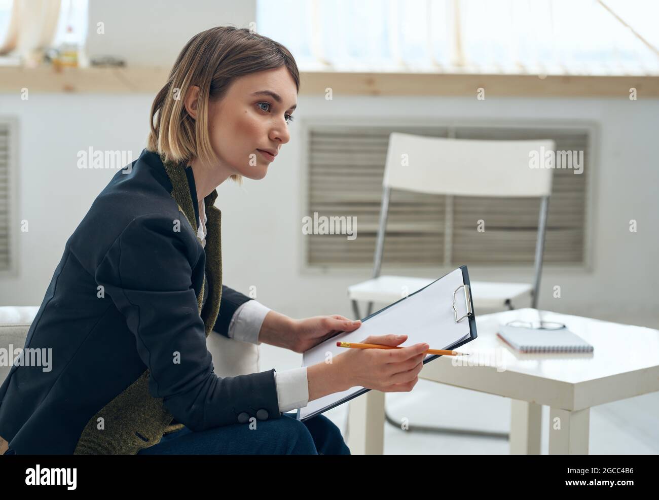 woman sitting in the office near the window work resume professional ...