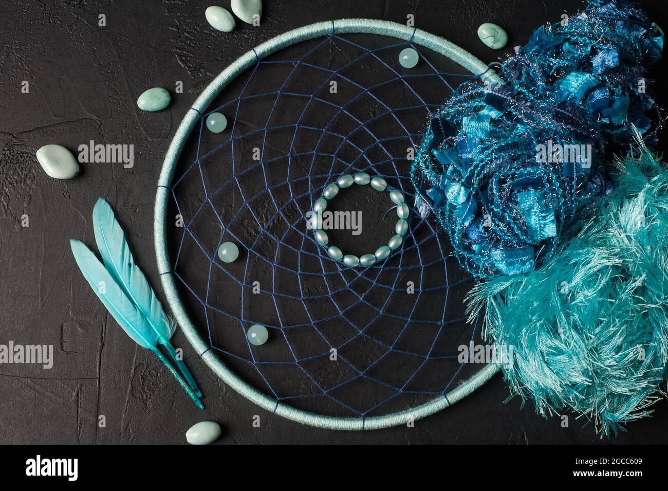 Blue dream catcher flat lay on black concrete background with gemstone ...