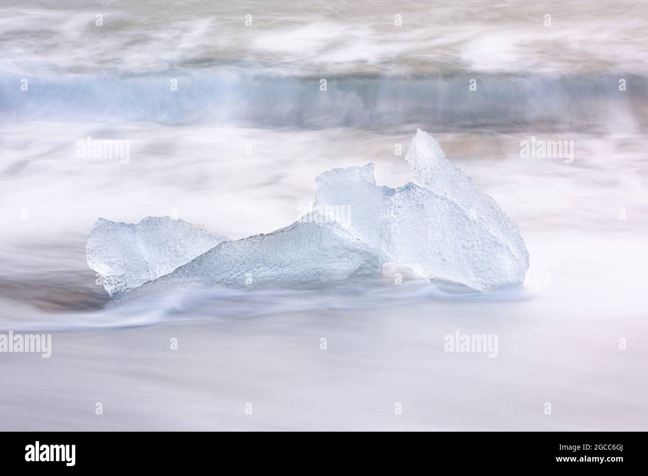 A scenic view of a Jokulsarlon glacier lagoon reflected in the sea in ...