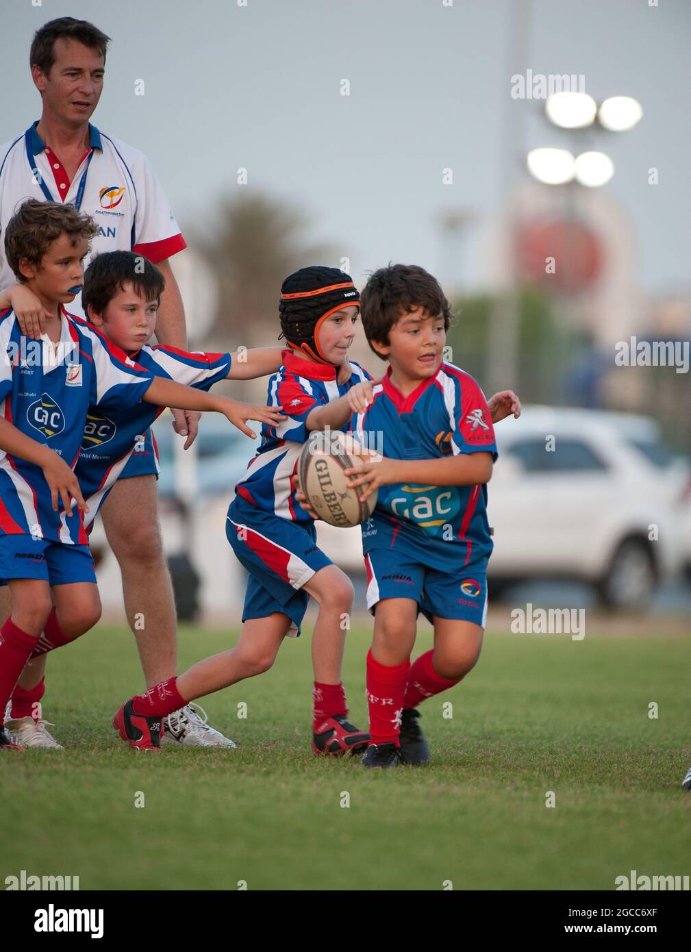 young kids playing rugby in abu dhabi Stock Photo - Alamy