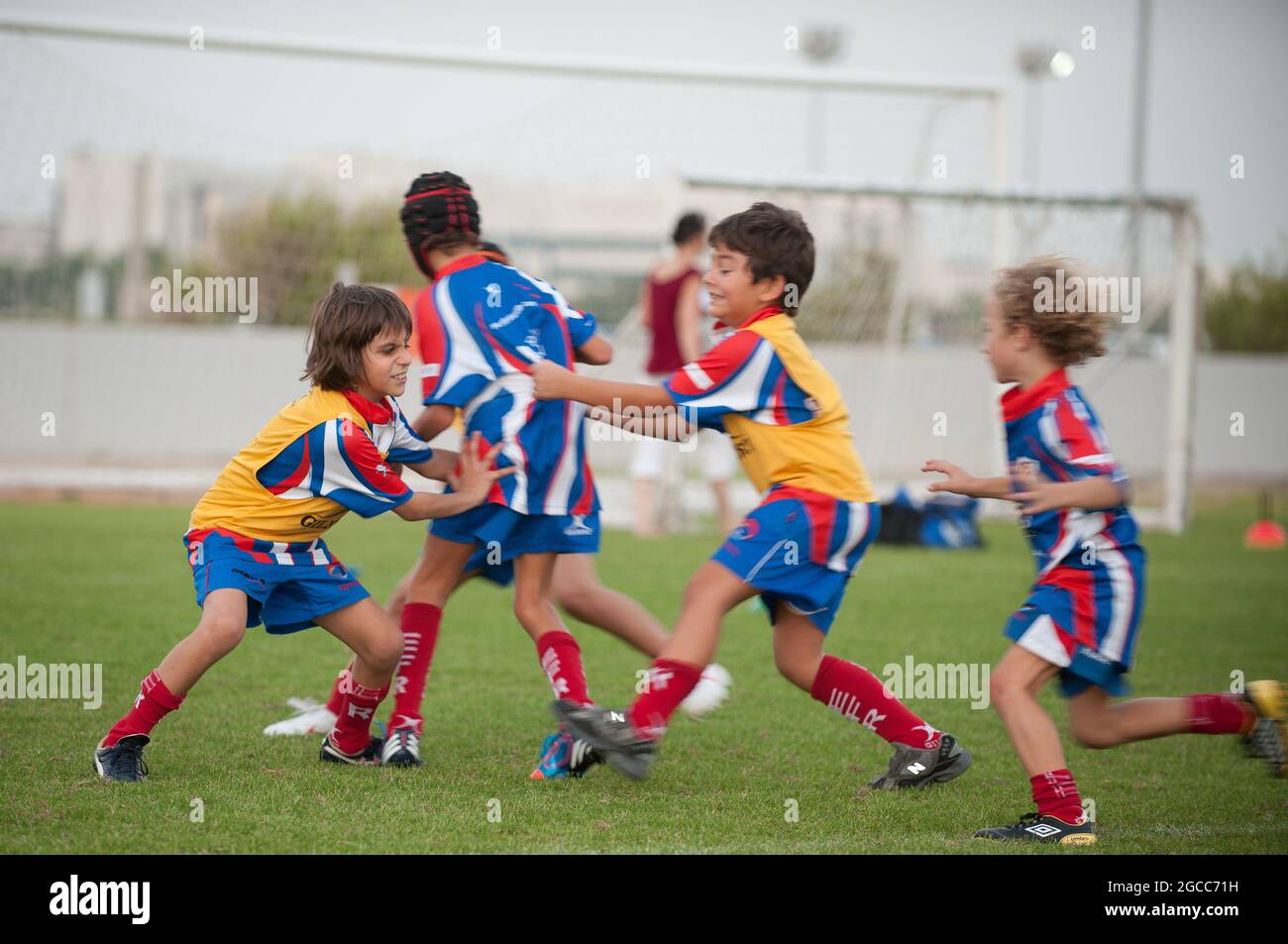 young kids playing rugby in abu dhabi Stock Photo - Alamy