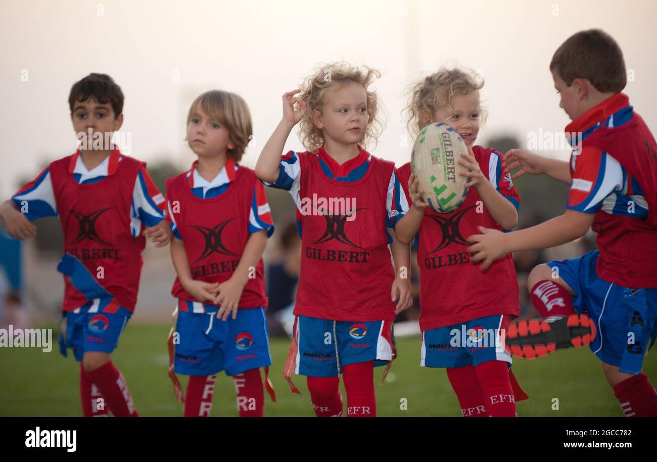 young kids playing rugby in abu dhabi Stock Photo - Alamy