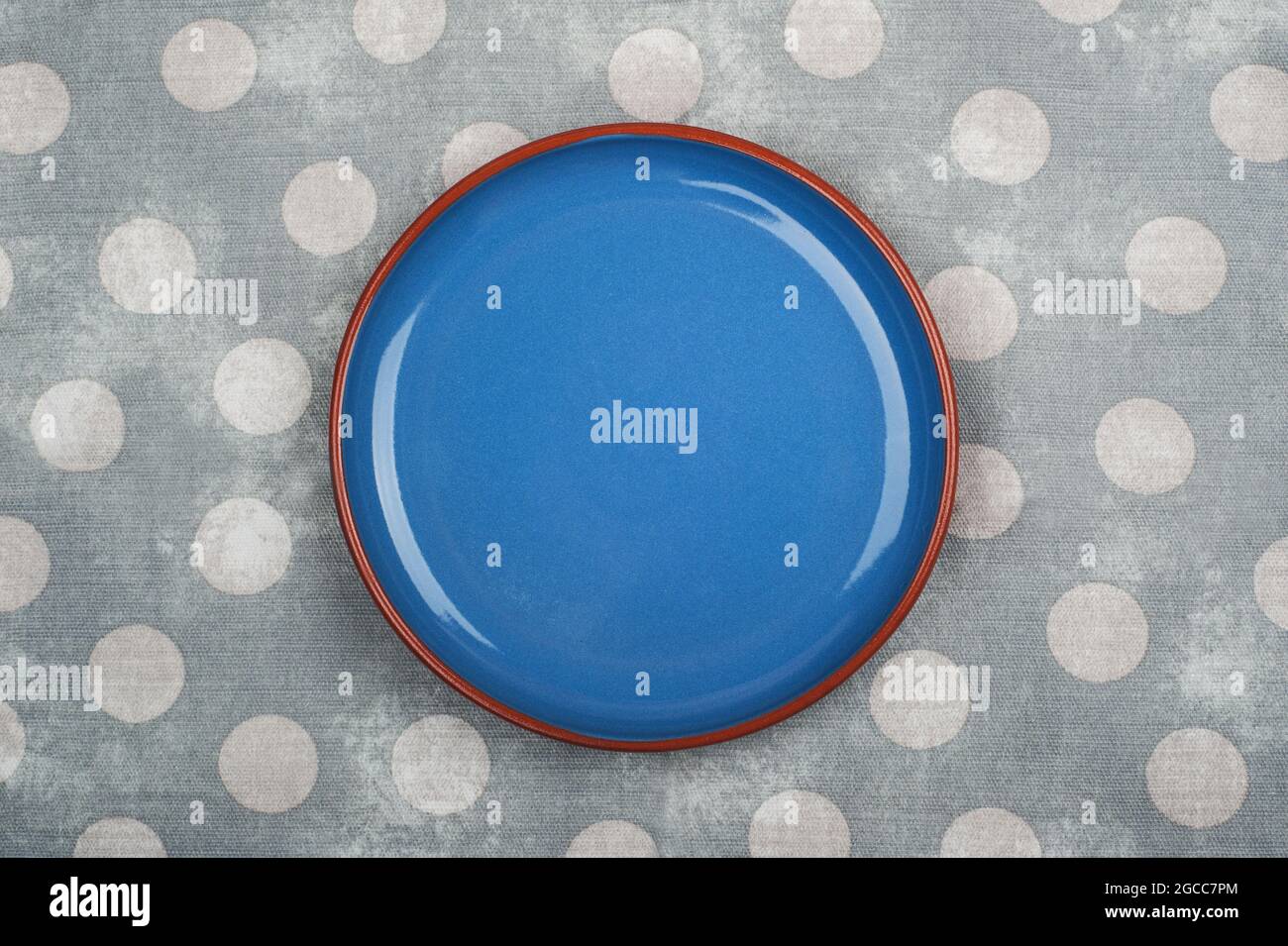 Empty blue plate and napkin over background. View from above with copy ...