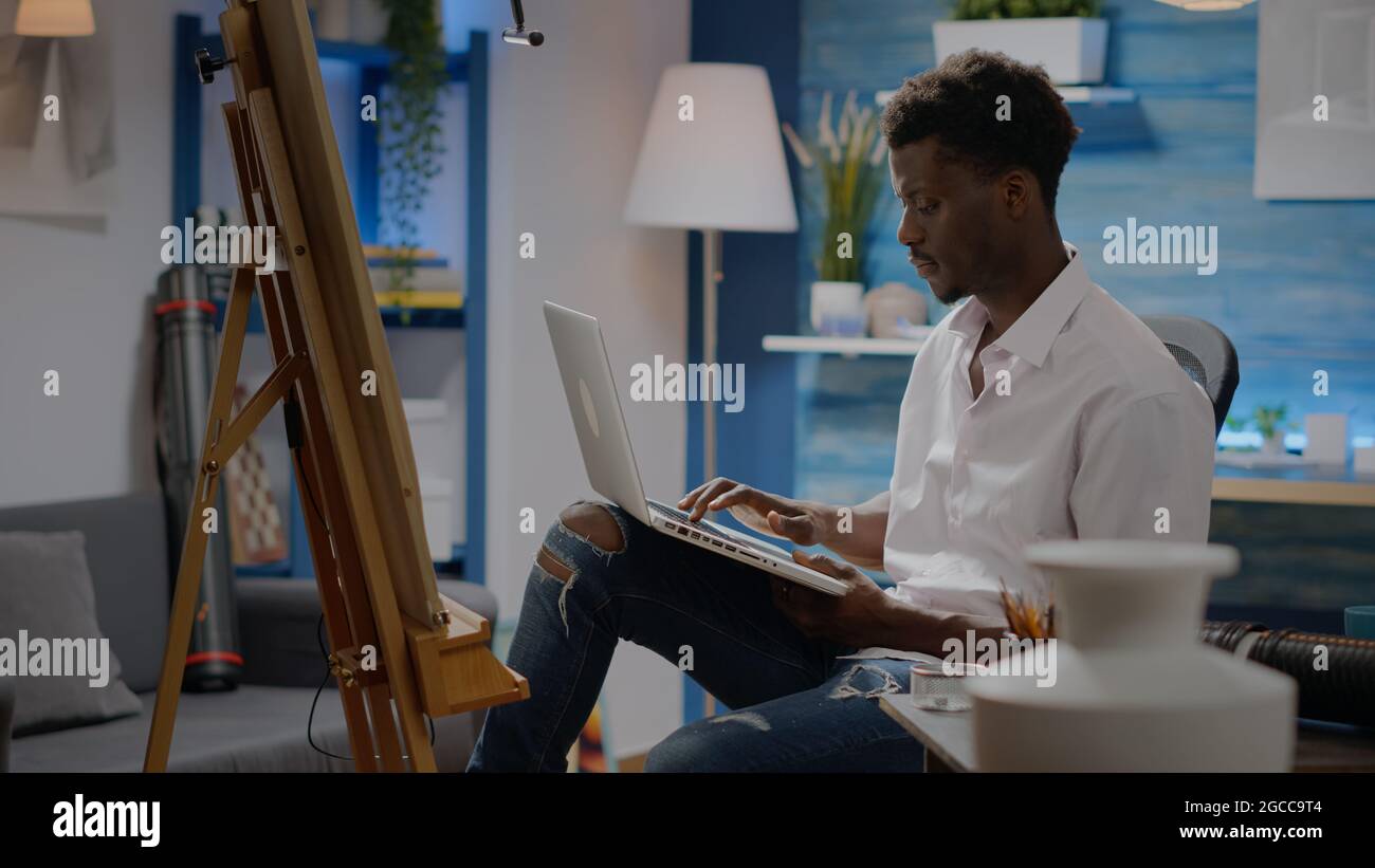 Black young artist using laptop technology for art concept and ...