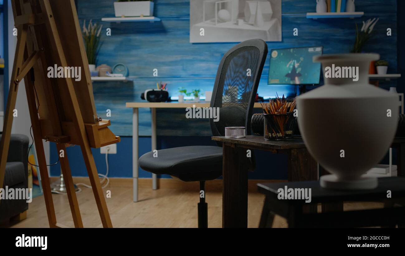 Empty creativity studio space with white canvas and easel for ...