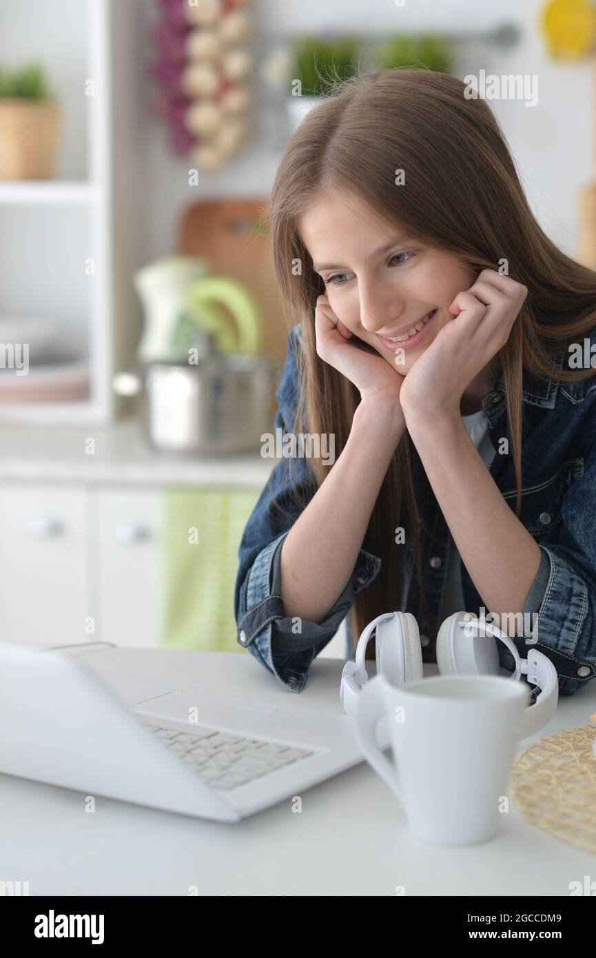 Portrait of beautiful girl using laptop at home Stock Photo - Alamy