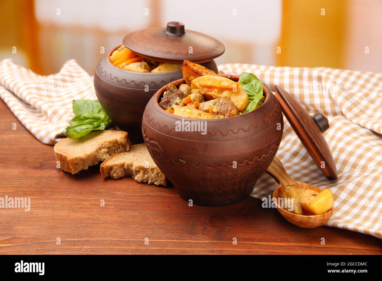 Homemade beef stir fry with vegetables in pots on wooden table, on ...