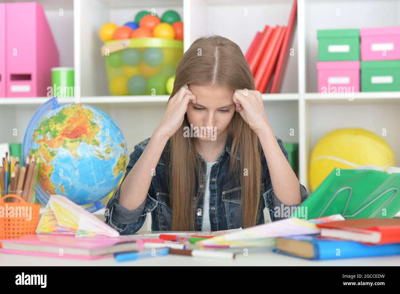 Cute girl doing home work at desk Stock Photo - Alamy