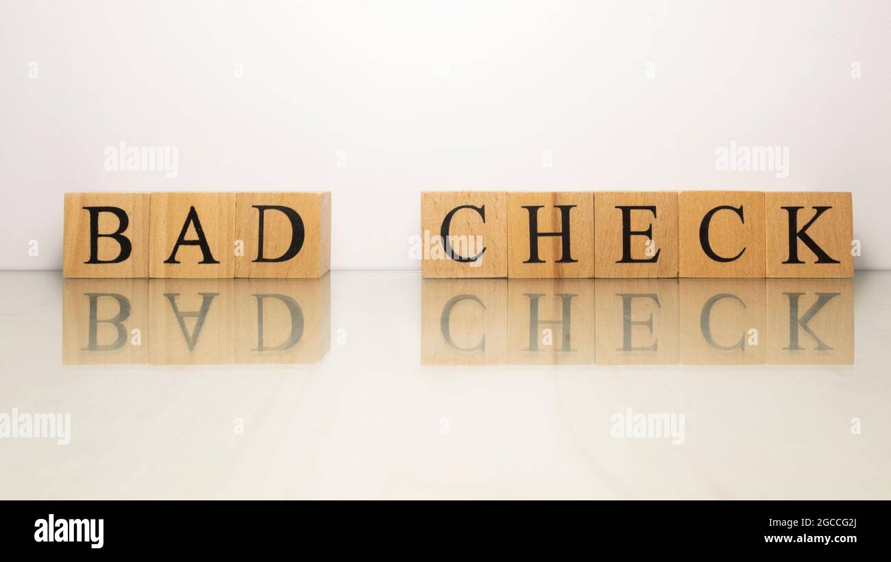 The name Bad check was created from wooden letter cubes. finance and ...