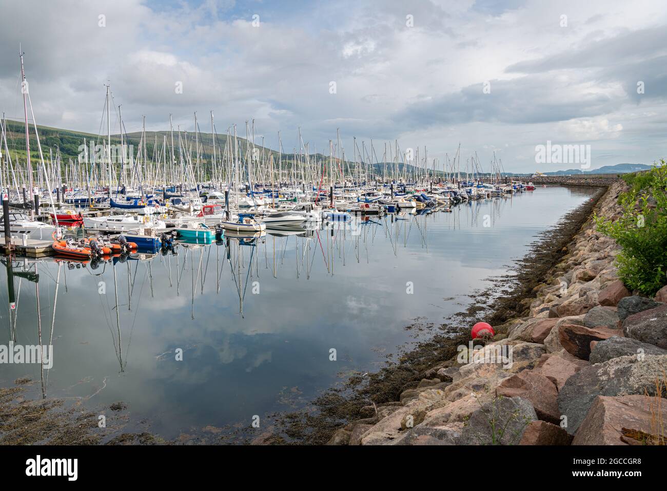 Boats and reflections in Largs Marina showing the protective rock wall ...