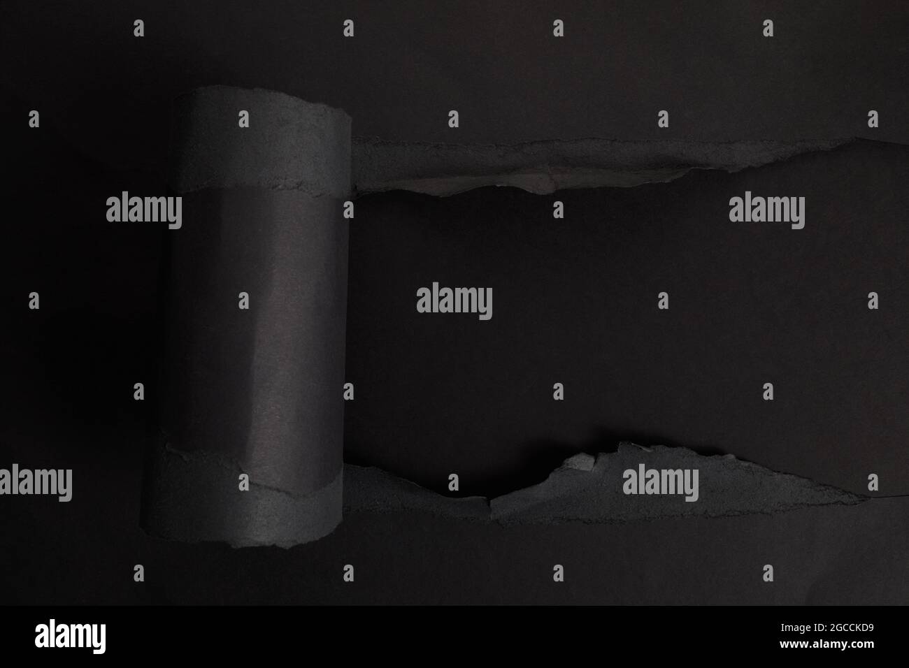 Torn black paper on black background. Top view Stock Photo - Alamy