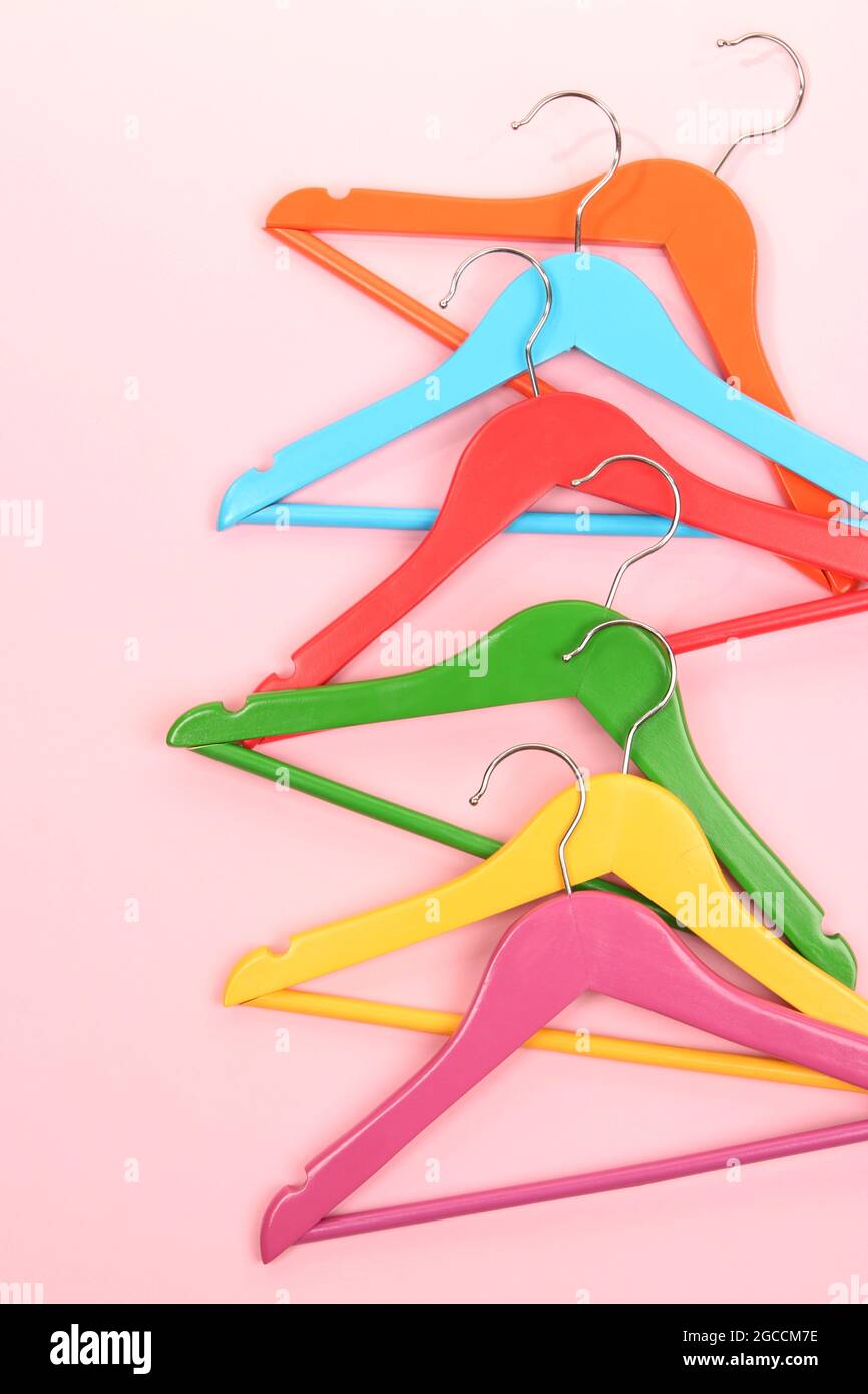 Colorful clothes hangers on pink background Stock Photo - Alamy