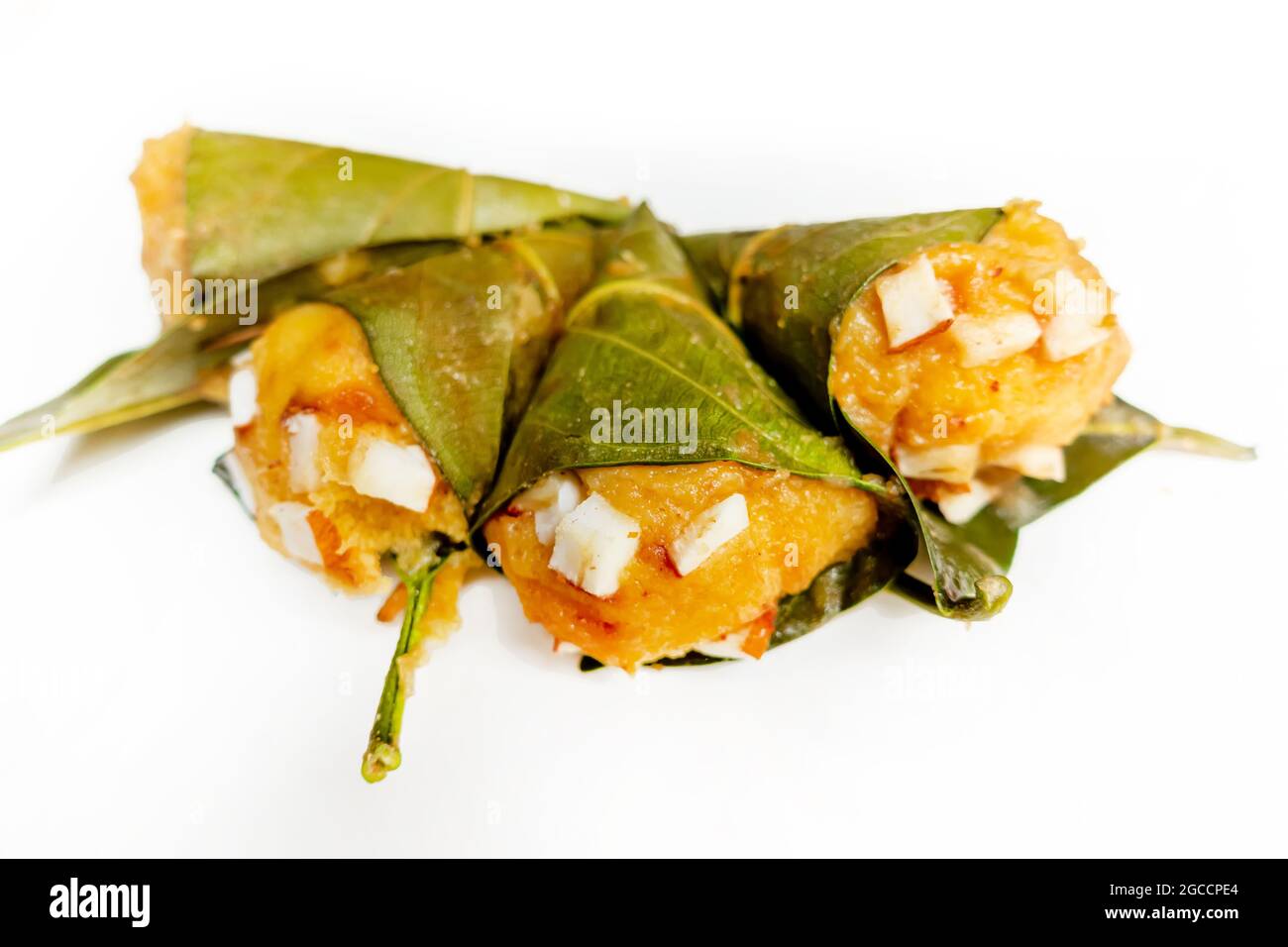 Traditional steamed ripe palmyra palm fruit cake wrapped with jackfruit ...