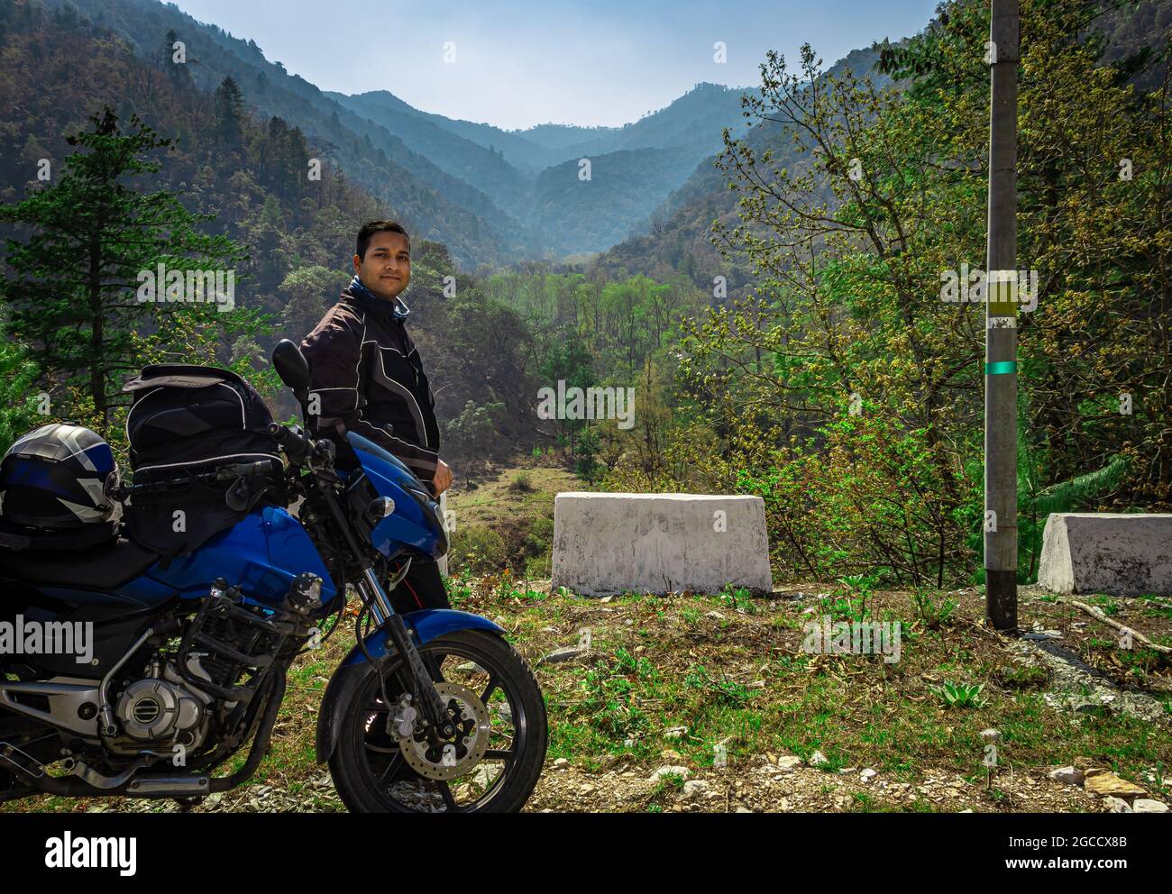man motorcyclist with his motorcycle and beautiful natural view at ...