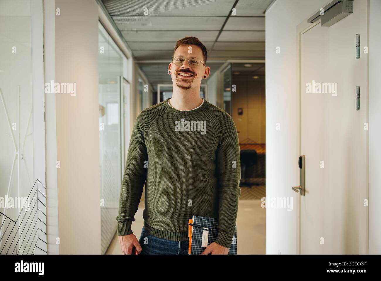 Positive male executive in office. Portrait of a businessman in office ...