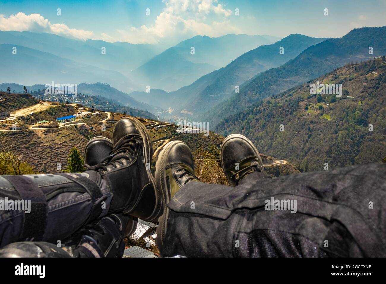 couple rider toe pointed toward the mountain curvy road at morning ...