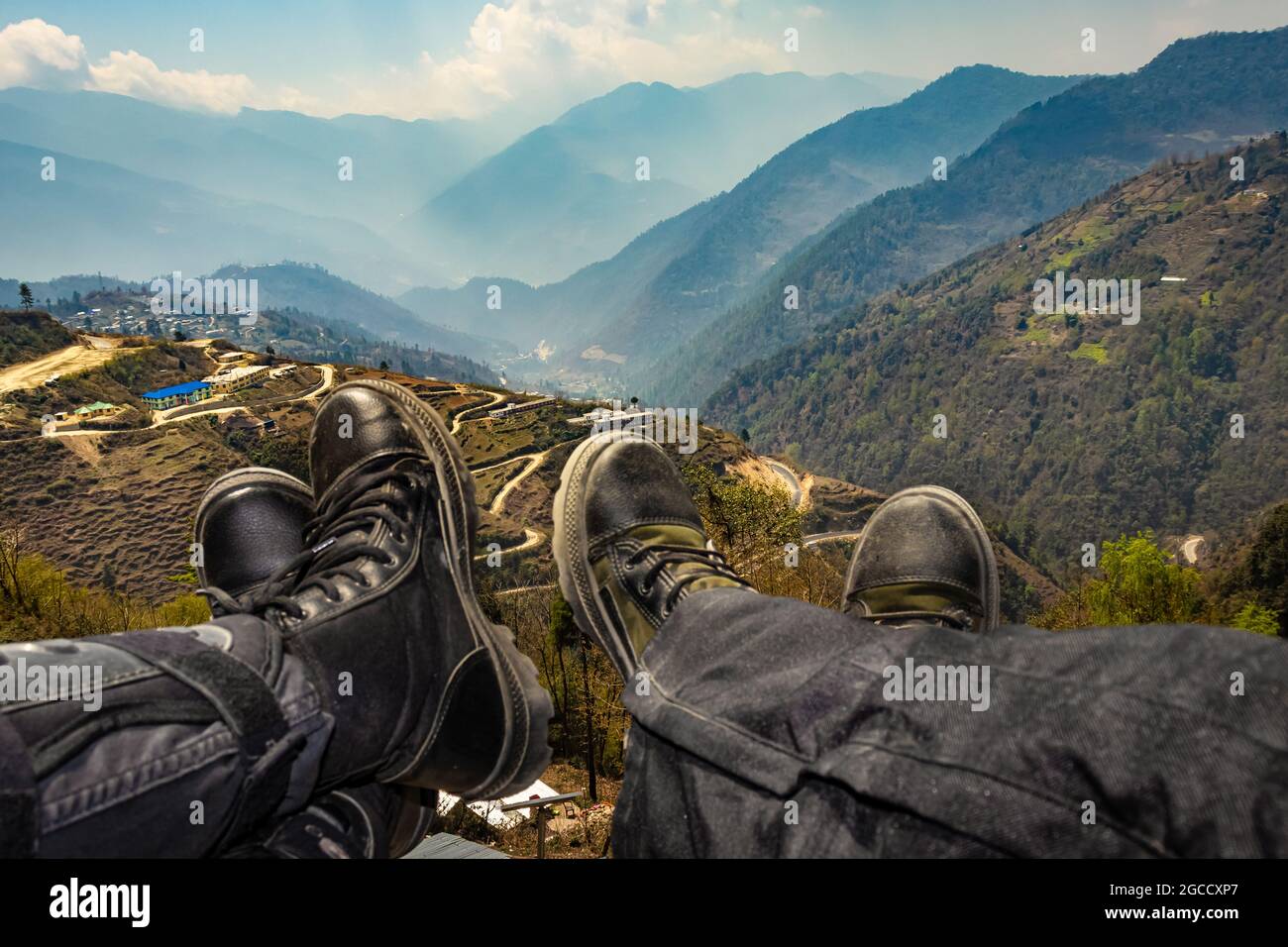 couple rider toe pointed toward the mountain curvy road at morning ...