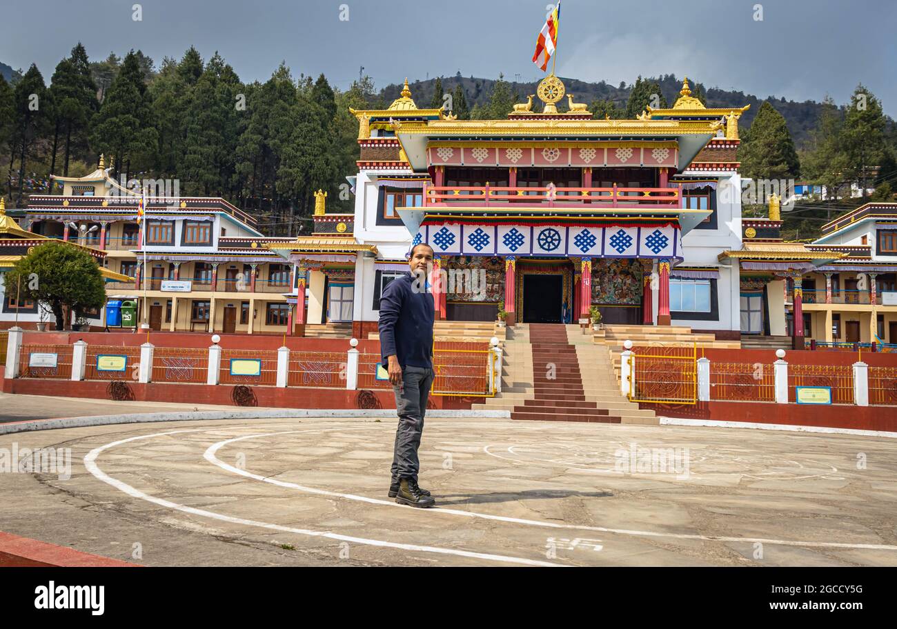 young man standing in front of ancient monastery at day image is taken ...