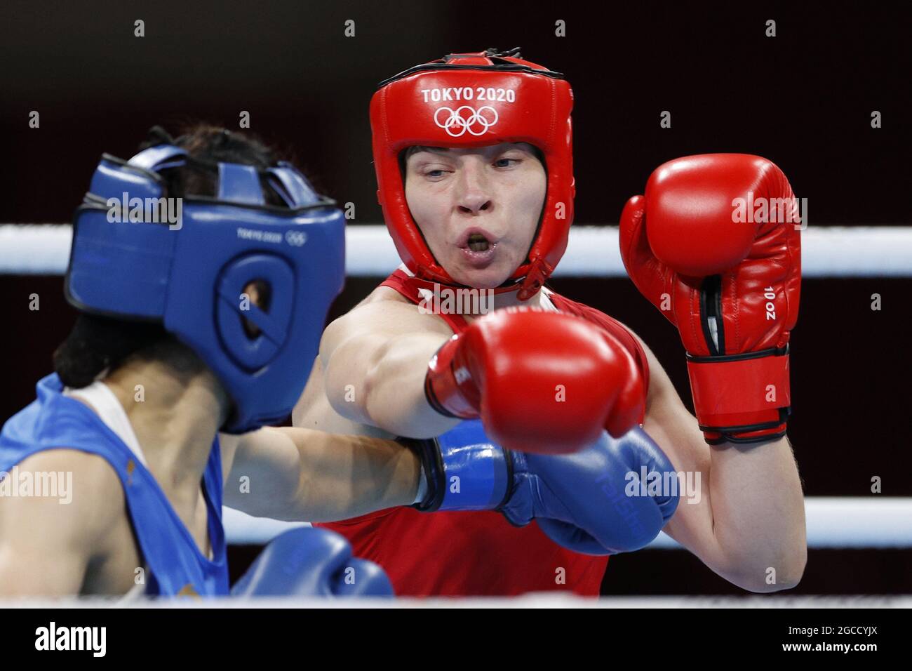 Britain's Lauren Price (facing camera) and China's Li Qian compete in ...