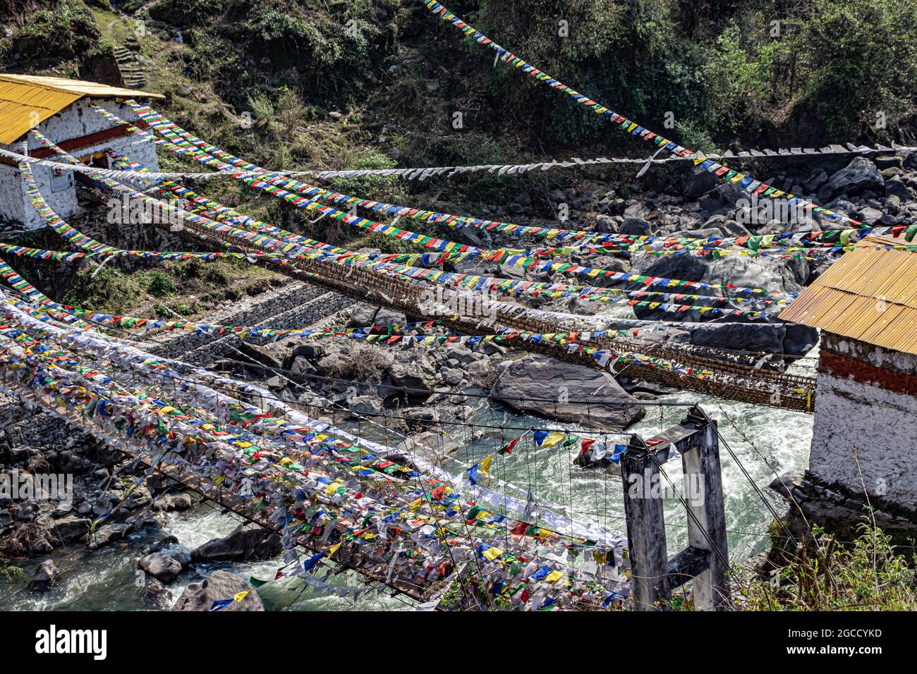 ancient holy iron bridge with many buddhist holy flags from top angle ...