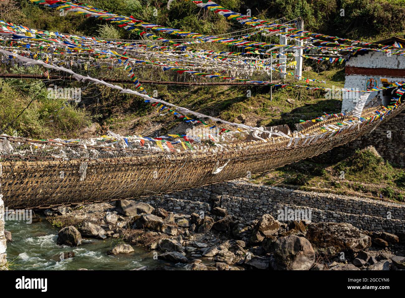ancient holy iron bridge with many buddhist holy flags from flat angle ...