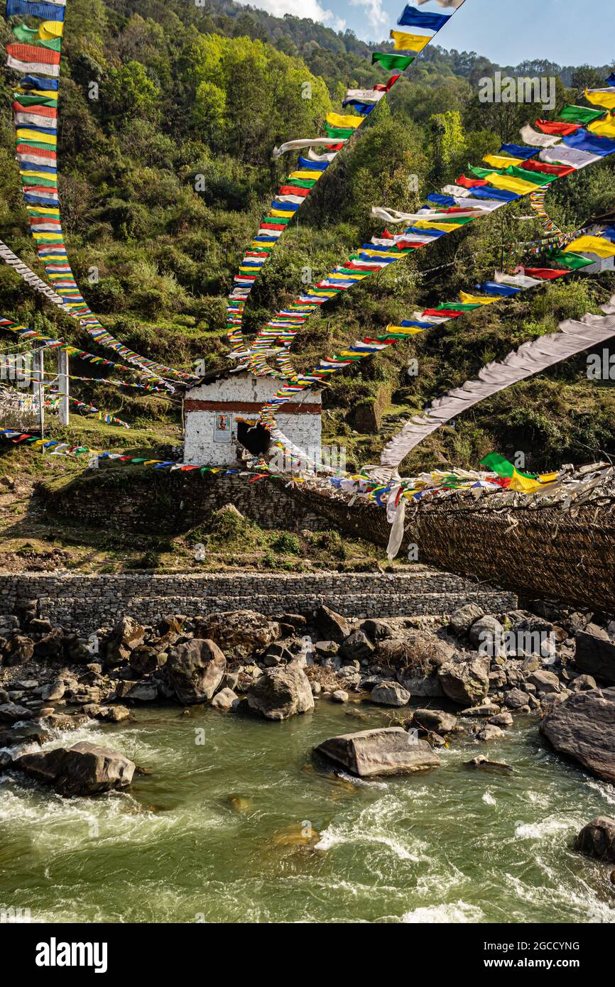 ancient holy iron bridge with many buddhist holy flags from flat angle ...