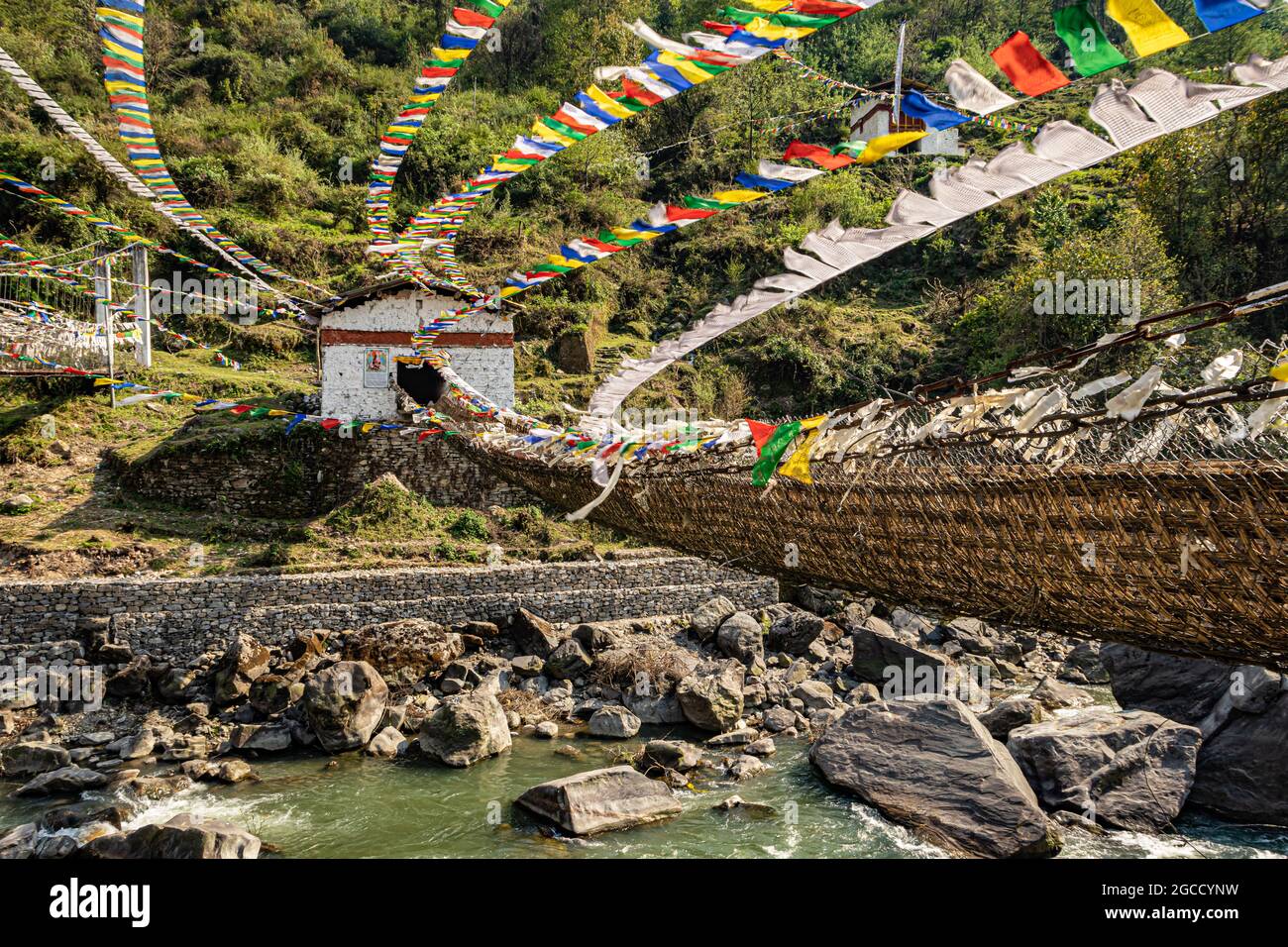 ancient holy bamboo bridge with many buddhist holy flags from flat ...