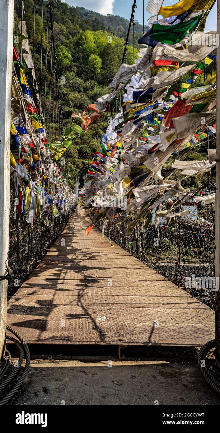 suspension iron bridge with many buddhist holy flags from unique ...