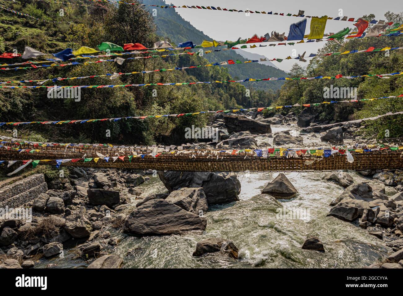 ancient holy bamboo bridge with many buddhist holy flags from unique ...