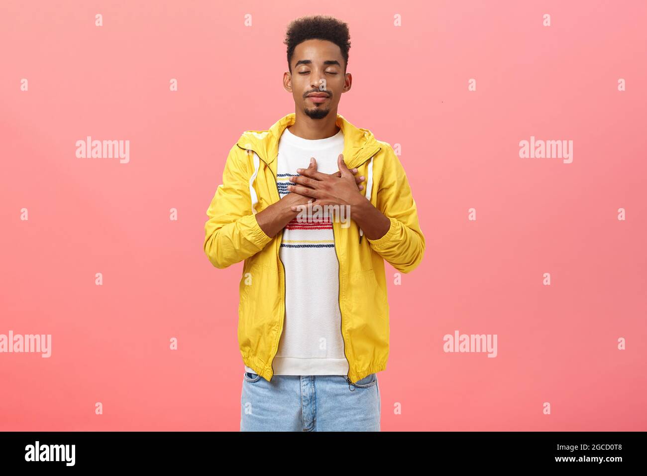 Attractive and stylish dark-skinned guy feeling warm and calm feelings ...