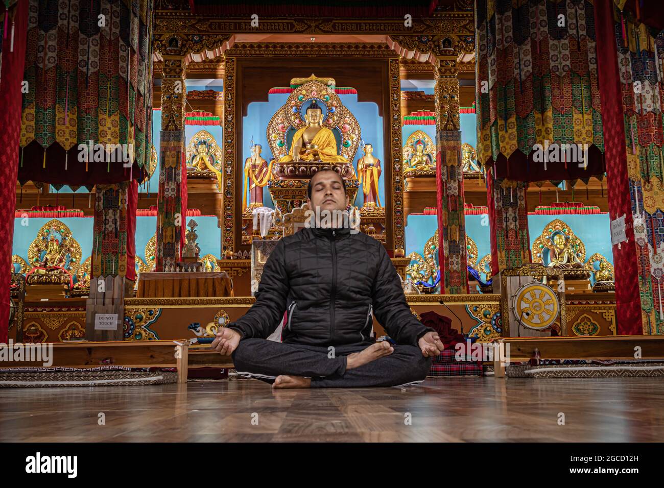 man meditating isolated inside buddhist monastery at morning from low ...