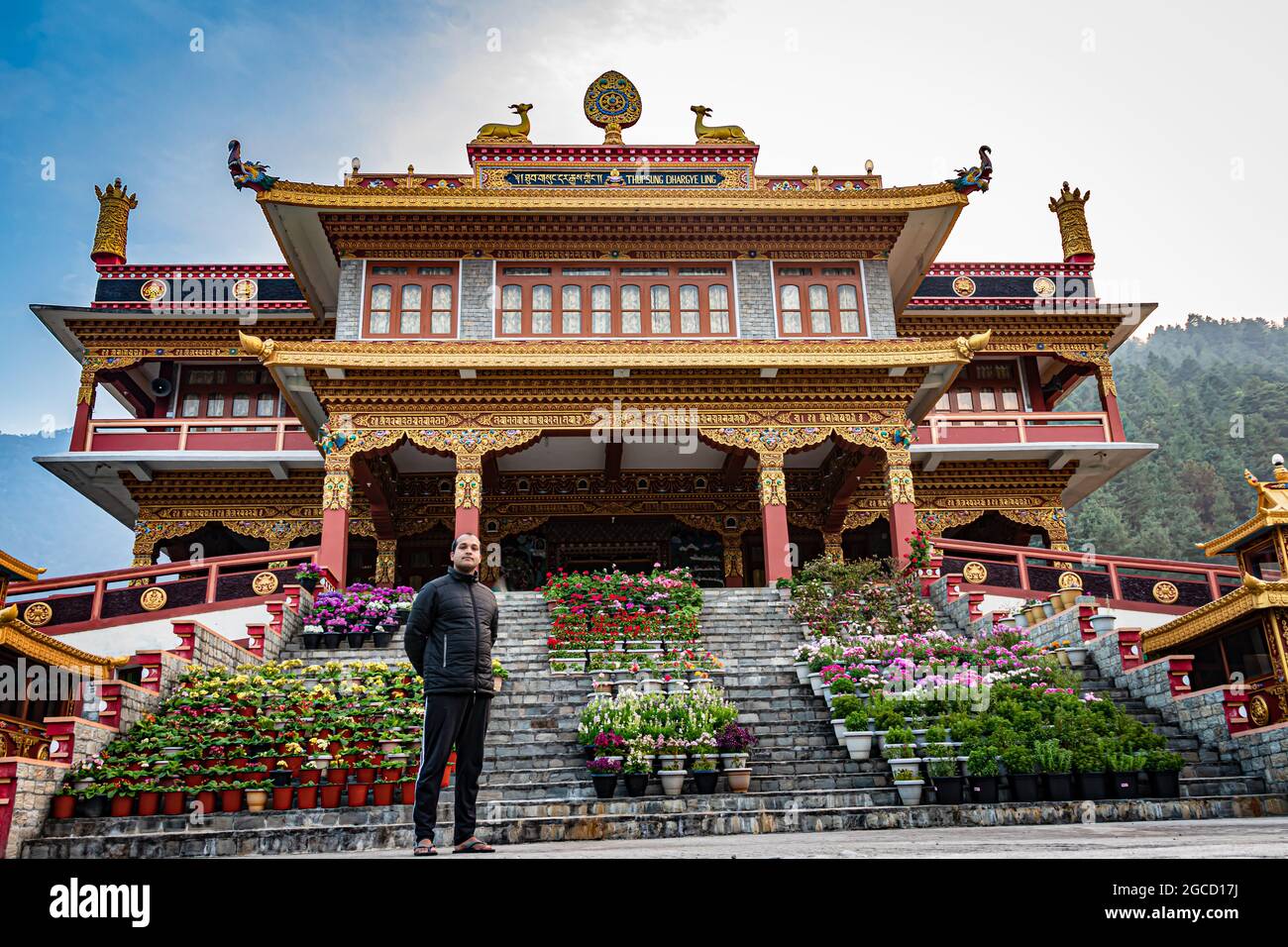 man standing near beautiful buddhist monastery at morning from flat ...