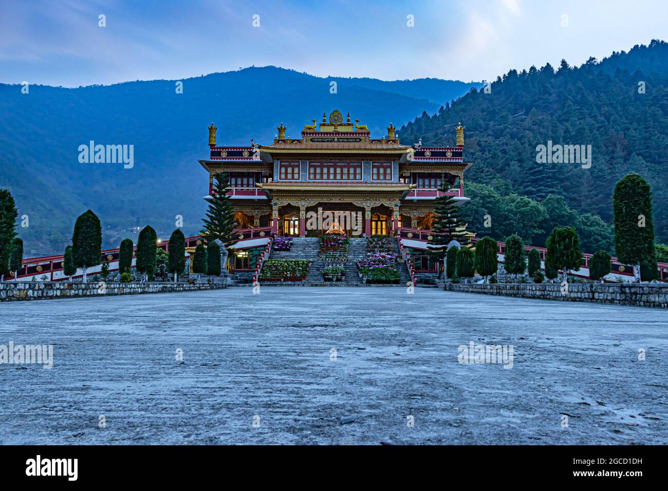 buddhist monastery at himalayan mountain foothills at evening from ...