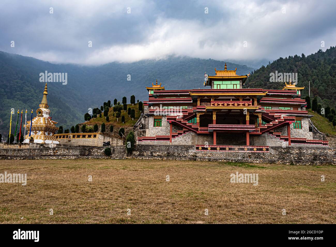 buddhist monastery at himalayan mountain foothills at evening from ...
