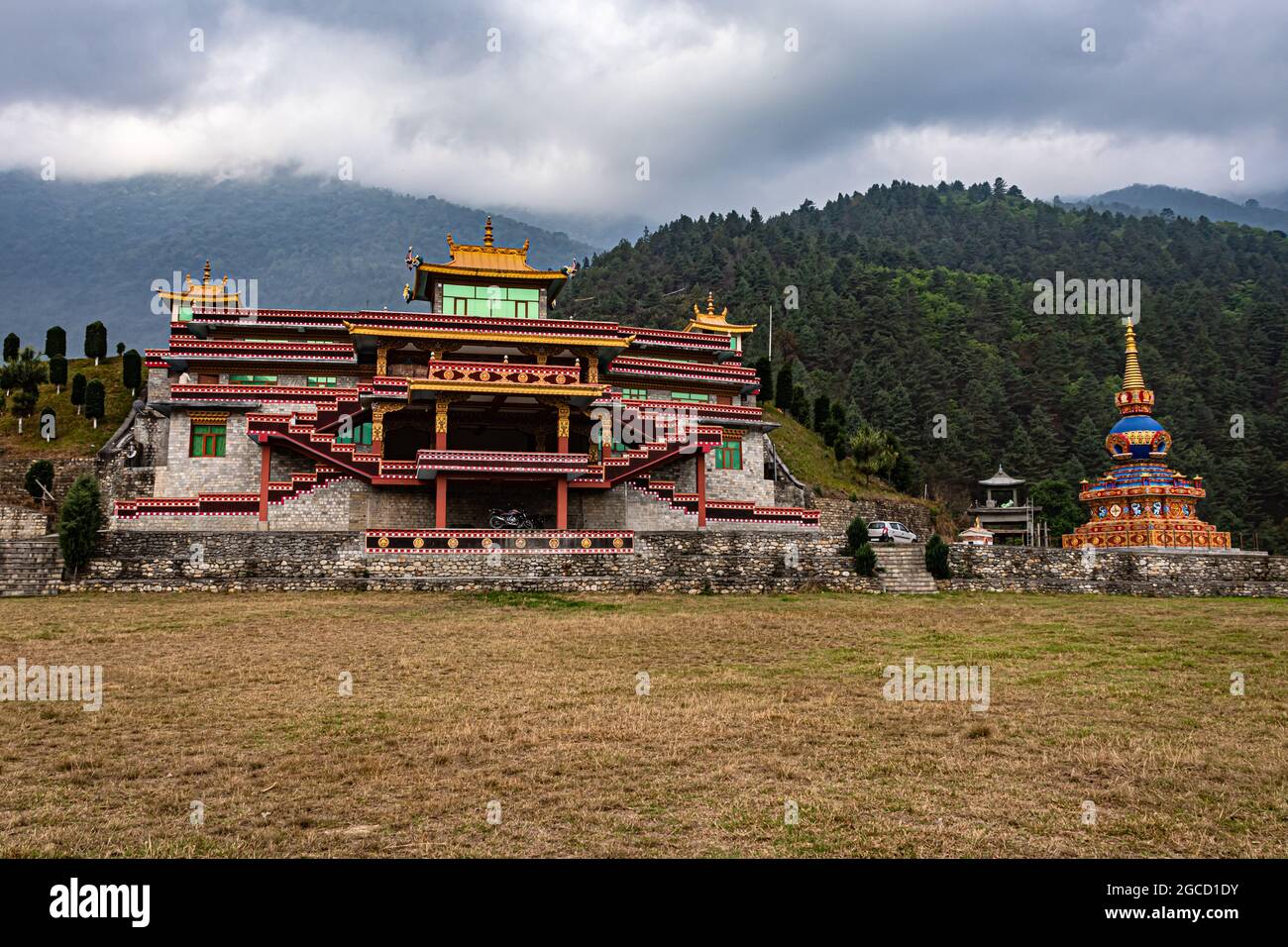 buddhist monastery at himalayan mountain foothills at evening from ...