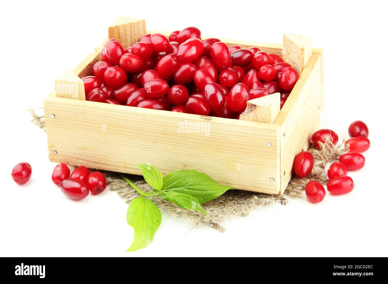 Fresh cornel berries in wooden crate, isolated on white Stock Photo - Alamy