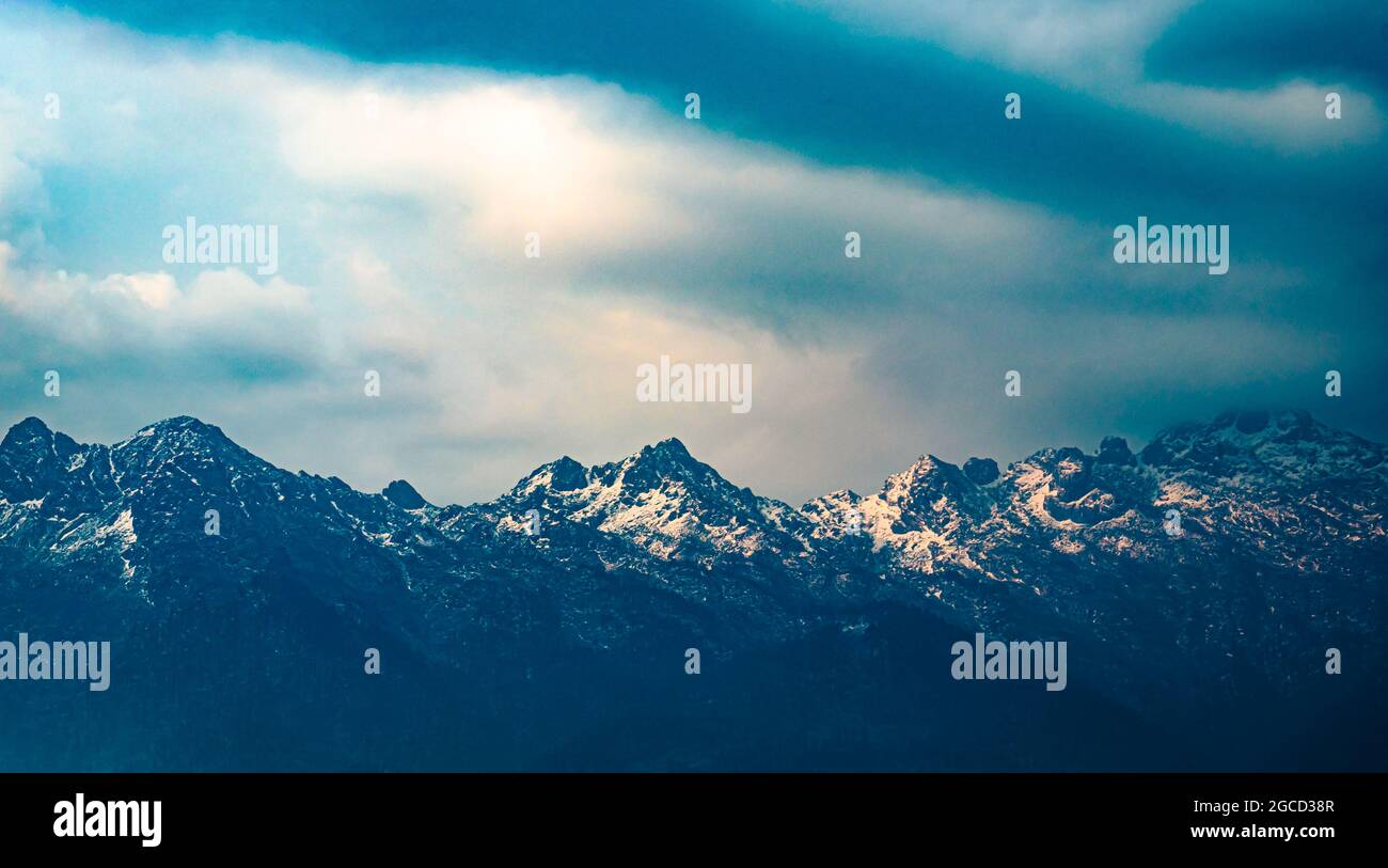 himalayan snow cape mountains with dramatic sky at evening image is ...